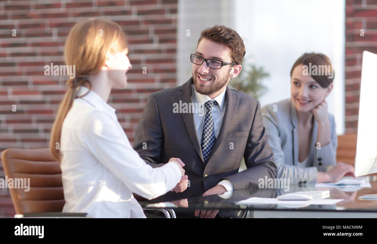 friendly handshake between colleagues in the office Stock Photo - Alamy