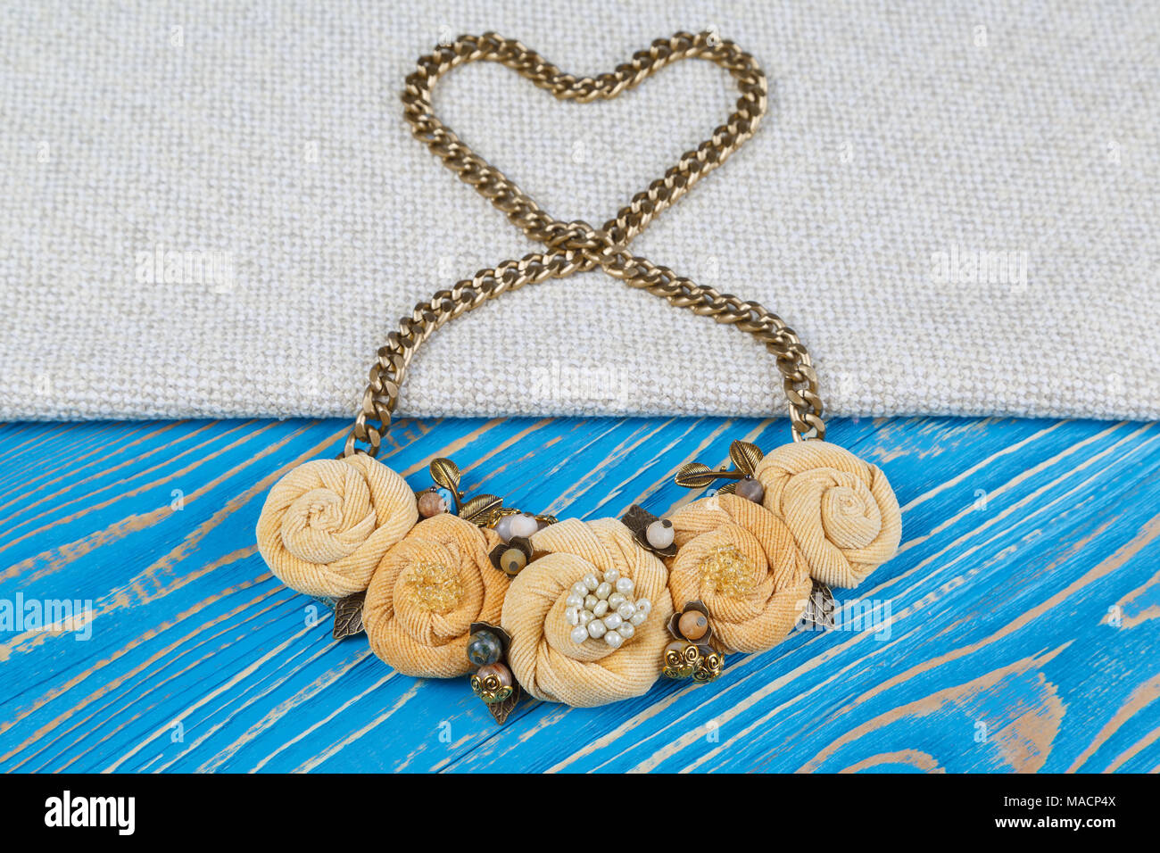 Handwork necklace of on a golden chain, laid out in the shape of a ...