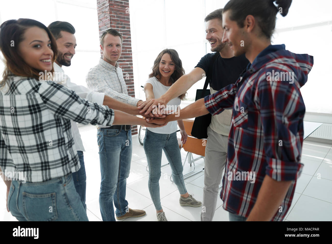 Business Team putting their hands together Stock Photo - Alamy