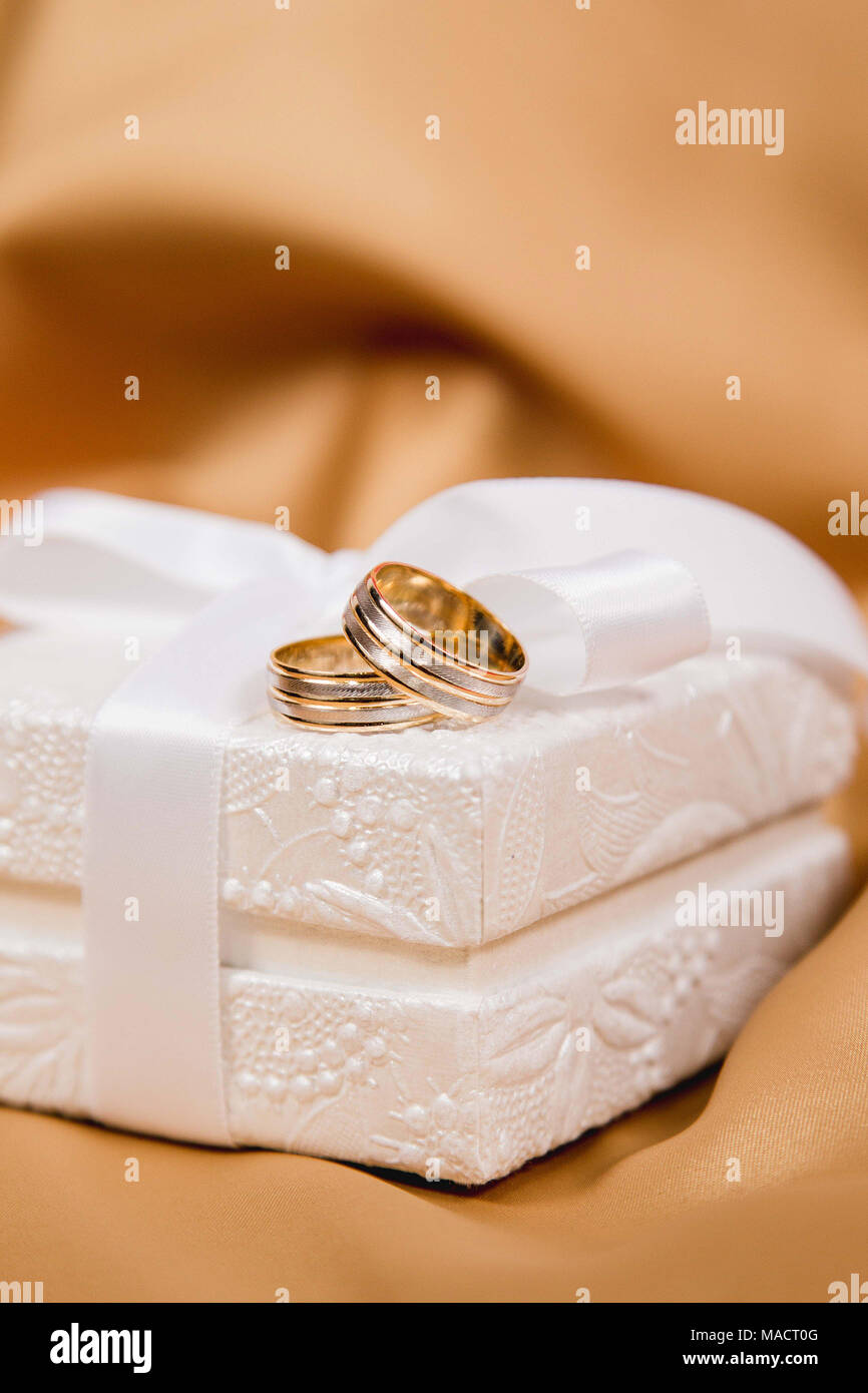 Beautiful wedding rings in white luxury box on yellow silk Stock Photo ...
