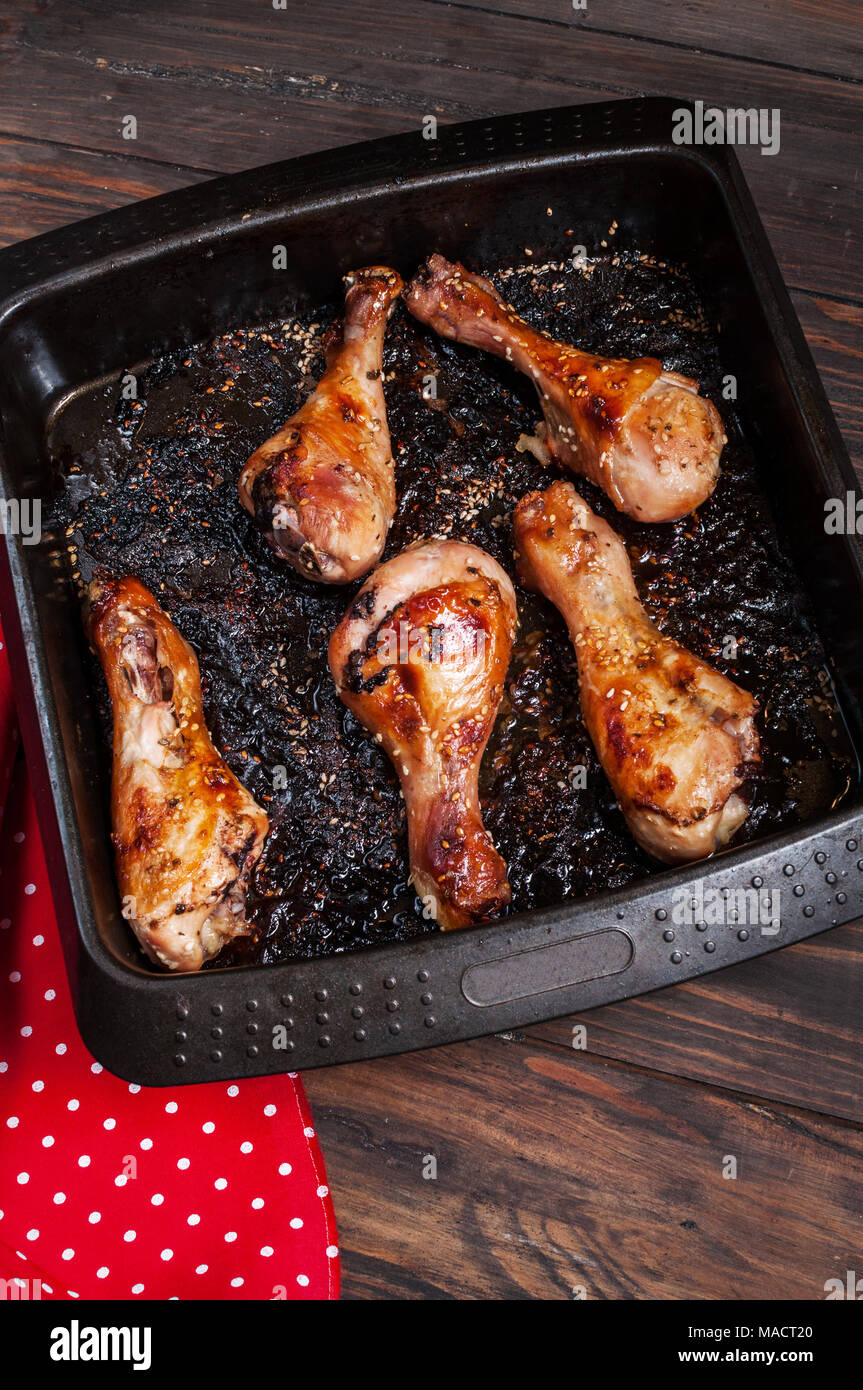 chicken legs on plate on wood background Stock Photo - Alamy