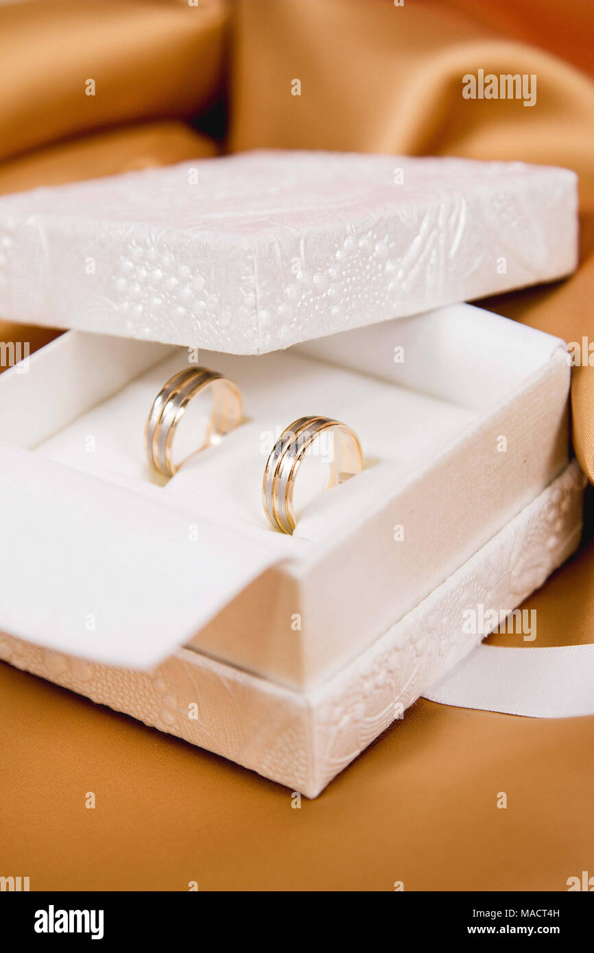 Beautiful wedding rings in white luxury box on yellow silk Stock Photo ...