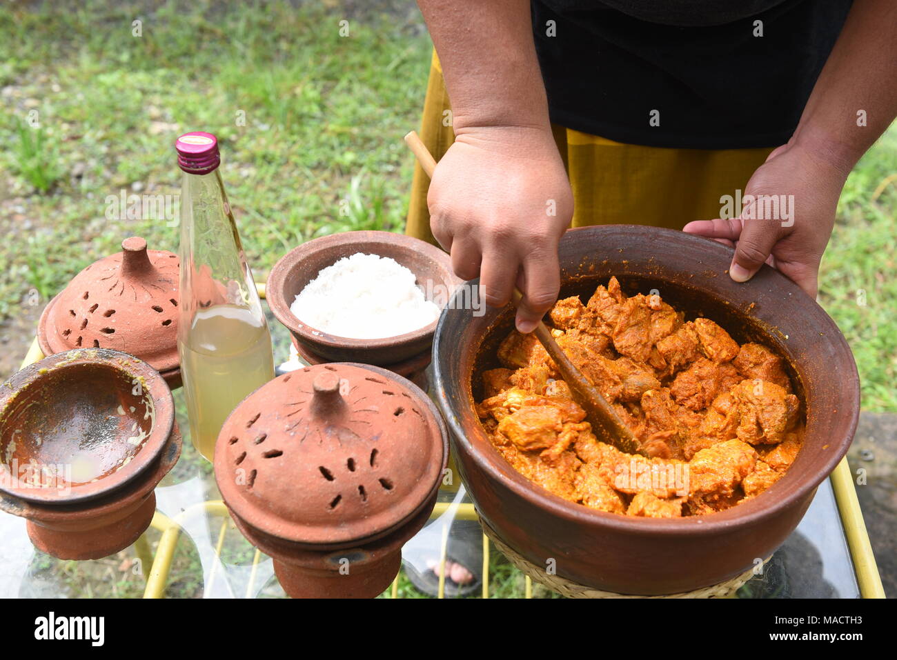 Cooking hot & spicy meat curry in clay pot Stock Photo - Alamy