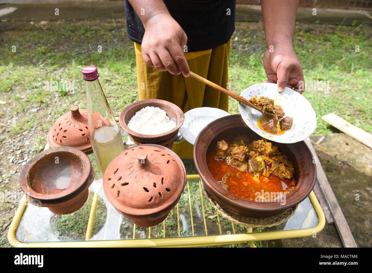 Cooking hot & spicy meat curry in clay pot Stock Photo - Alamy