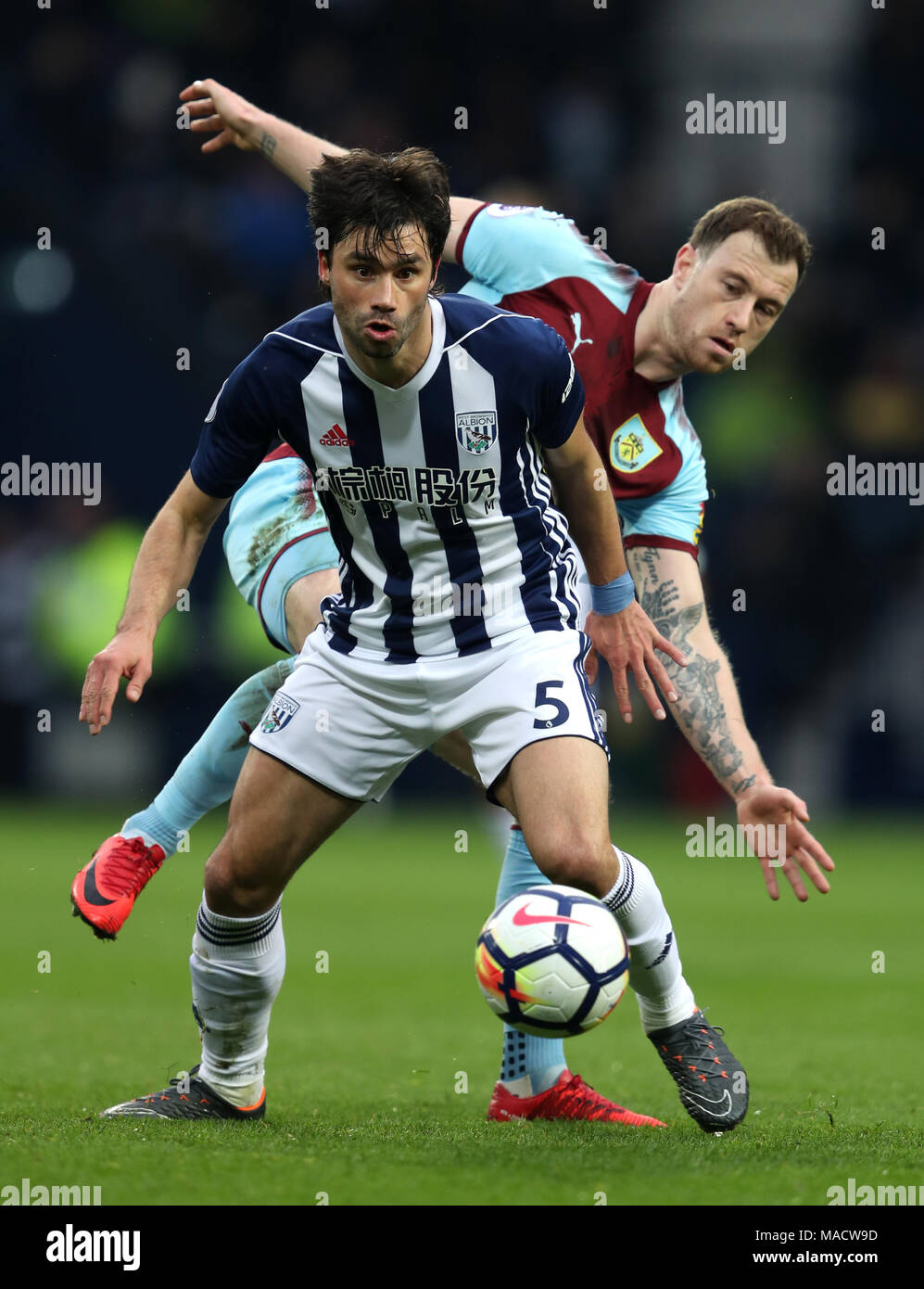 West Bromwich Albion's Claudio Yacob (front) and Burnley's Ashley ...