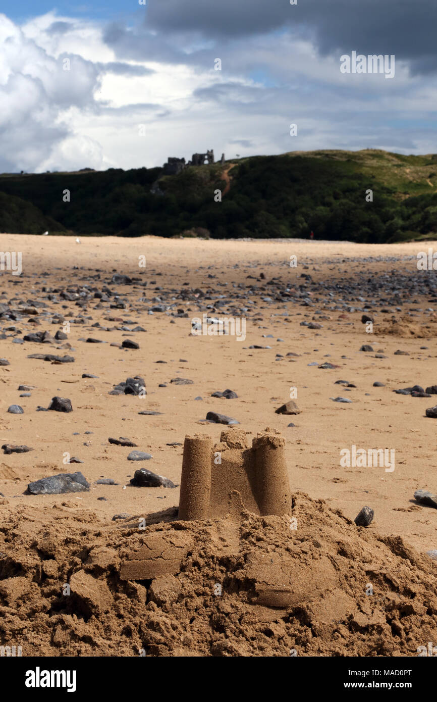 Sandcastle on the beach at Three Cliffs Bay, Gower, Wales, UK, with ...
