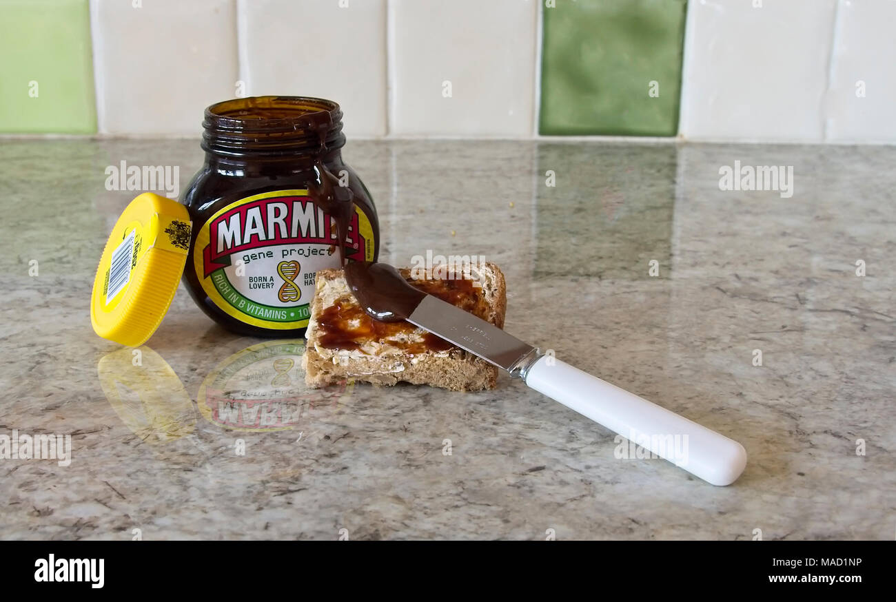 Opened jar of marmite with spread on piece of bread Stock Photo - Alamy