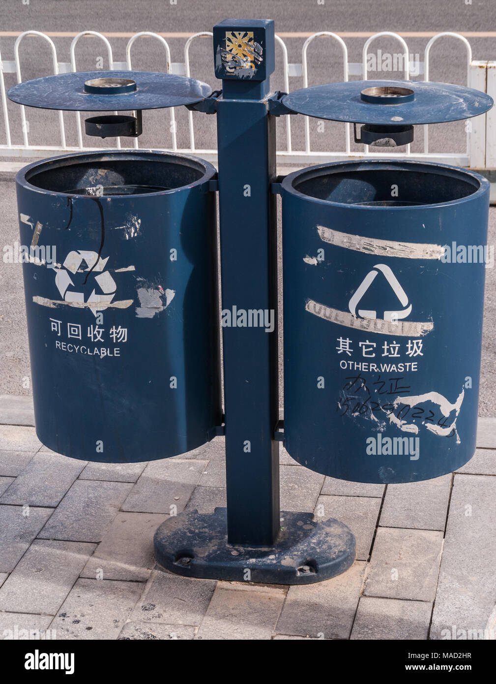 Beijing, China - April 26, 2010: Closeup of two blue garbage bins fixed ...