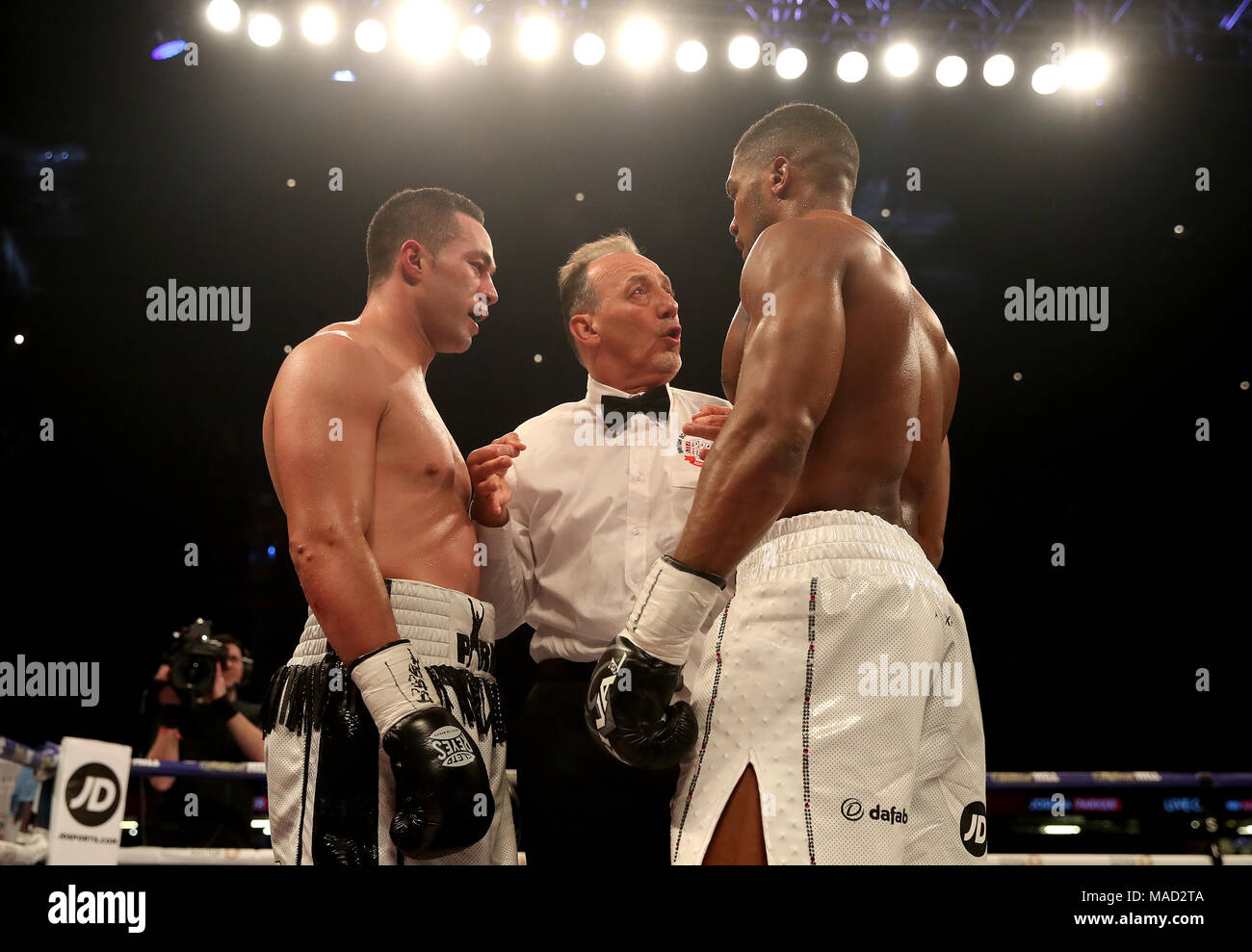 Referee Giuseppe Quartarone speaks with Joseph Parker (left) and Anthony Joshua in their WBA ...