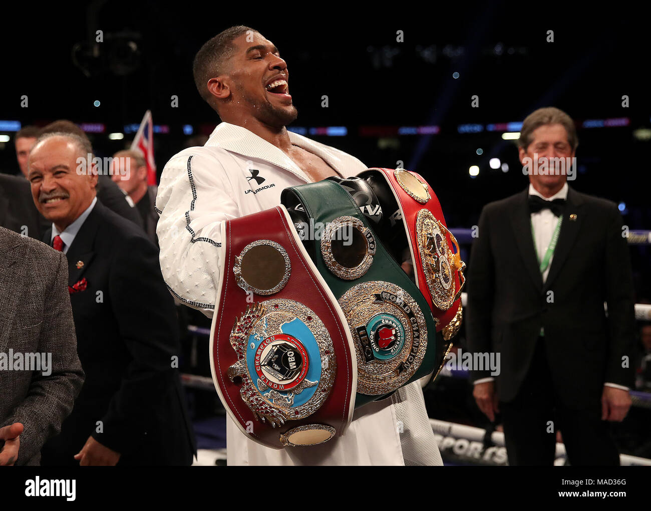 Anthony Joshua celebrates with his belts after victory over Joseph ...