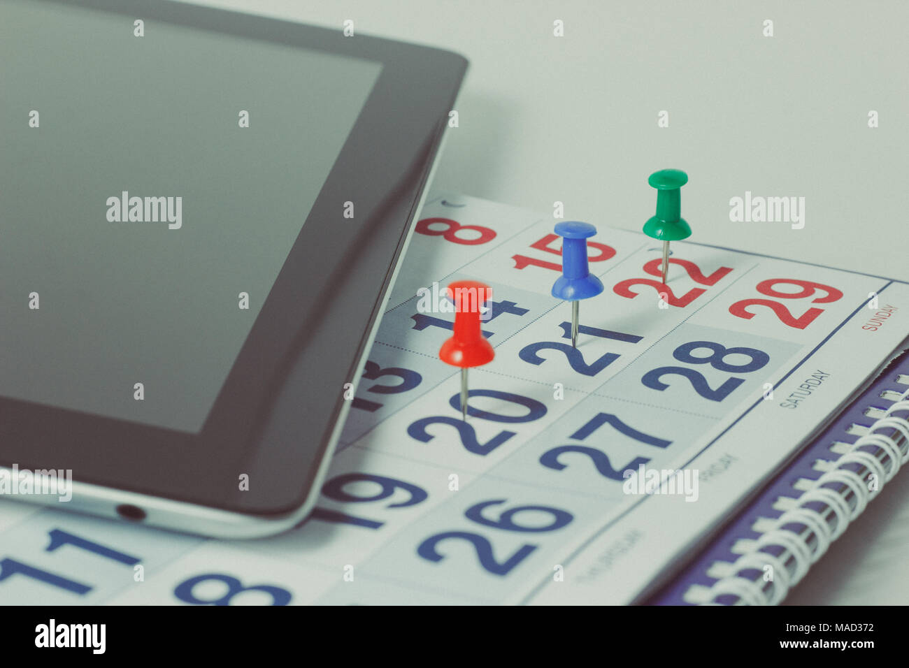 Wall calendar with pen and tablet Stock Photo - Alamy