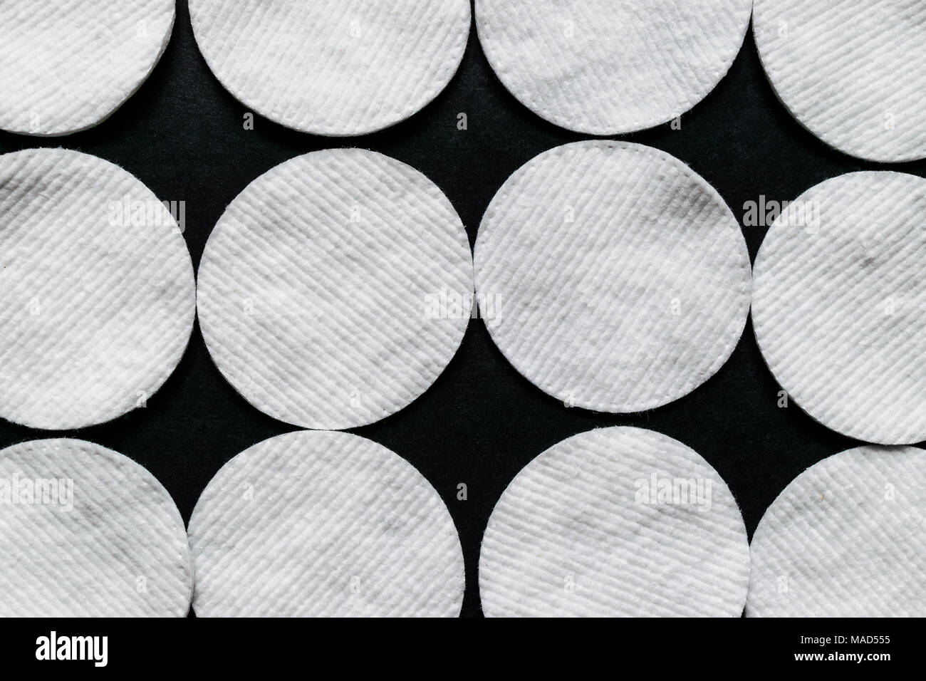 Soft, white and round pads on black background surface Stock Photo - Alamy