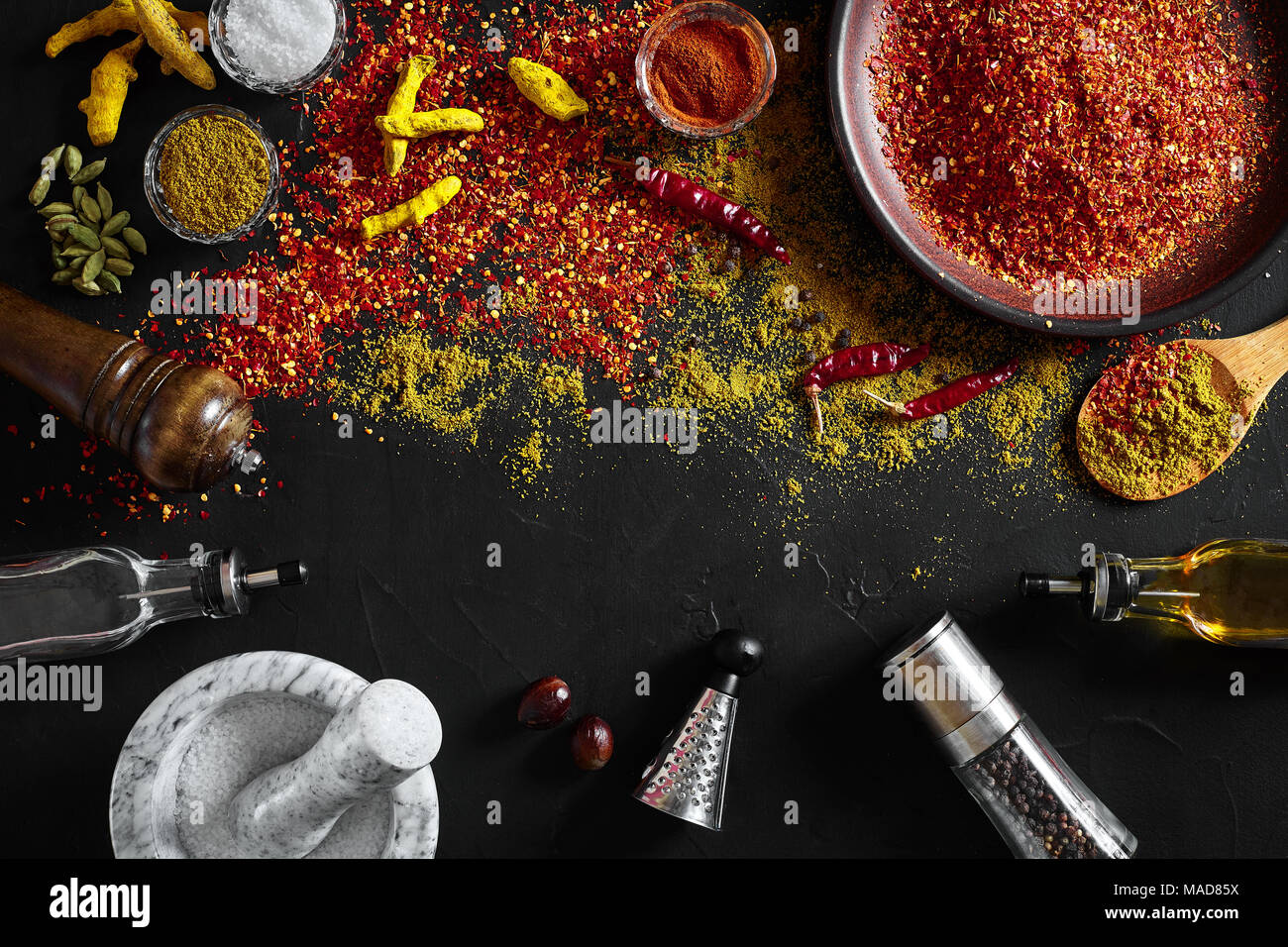 Cooking using fresh ground spices with mortar and small bowls of spice ...