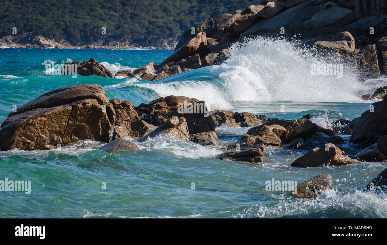 Detail of a wave breaking on the rocks Stock Photo - Alamy