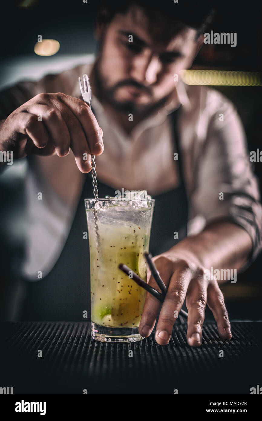 Bartender is stirring cocktail on the bar counter Stock Photo - Alamy