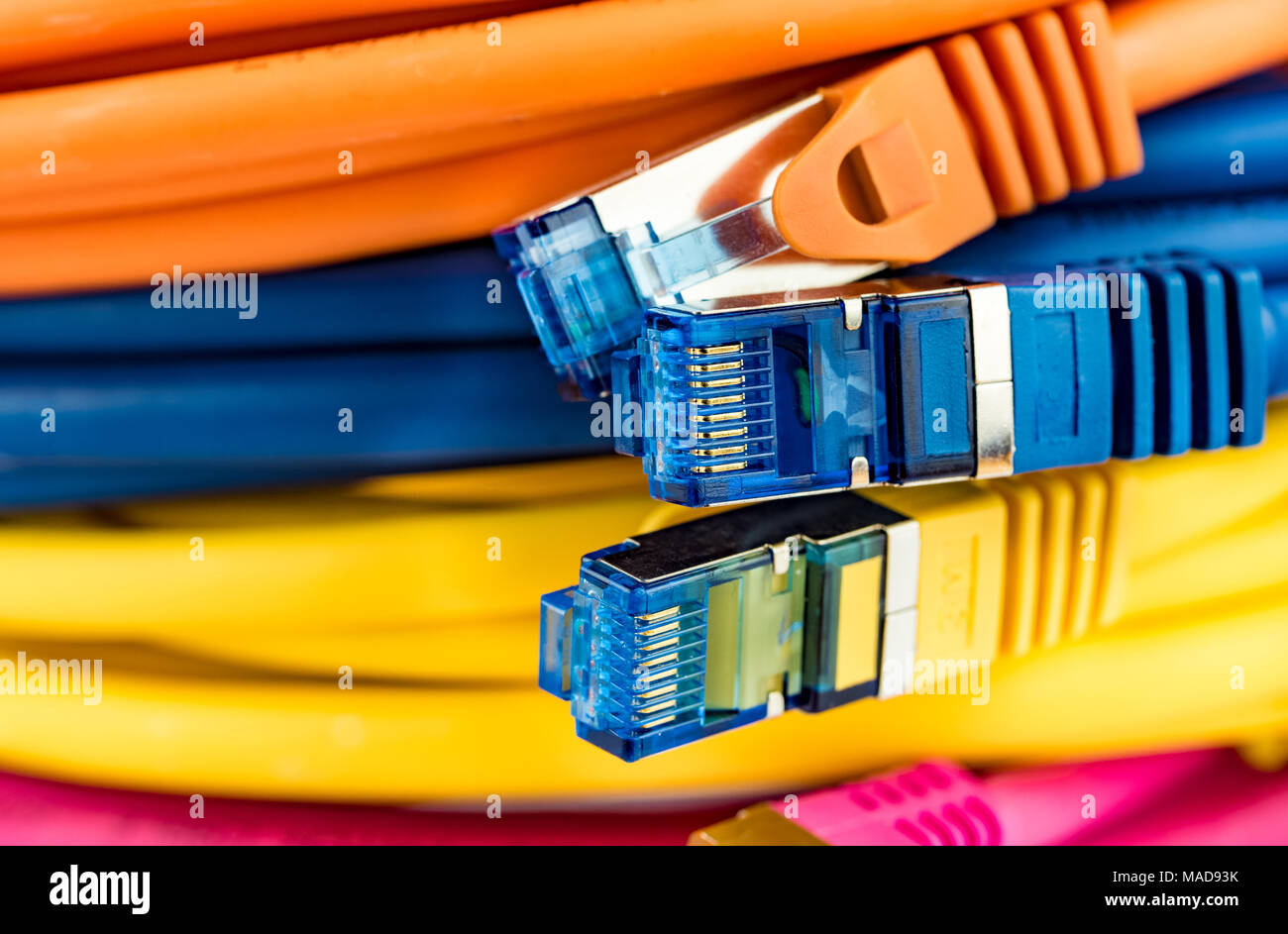 Power cable in orange, blue and yellow for communication in the network ...