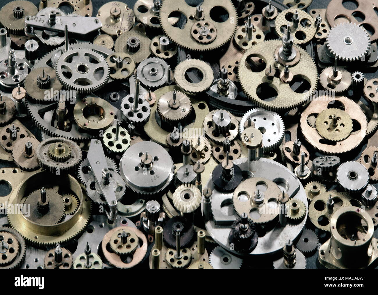 Gears and cogwheels many small, closeup background Stock Photo - Alamy