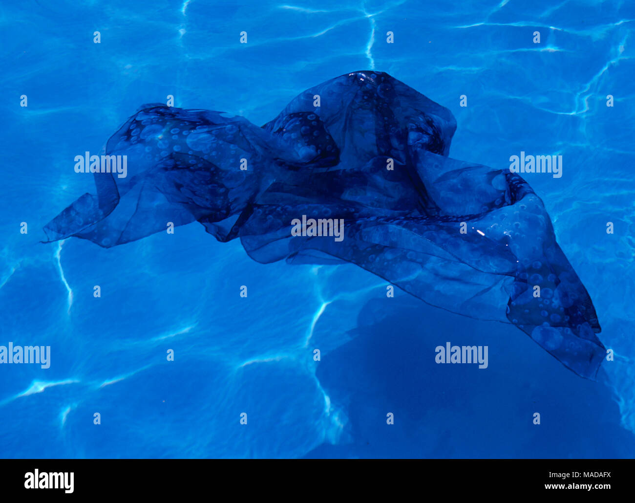 Blue fabric floating in pool Stock Photo - Alamy