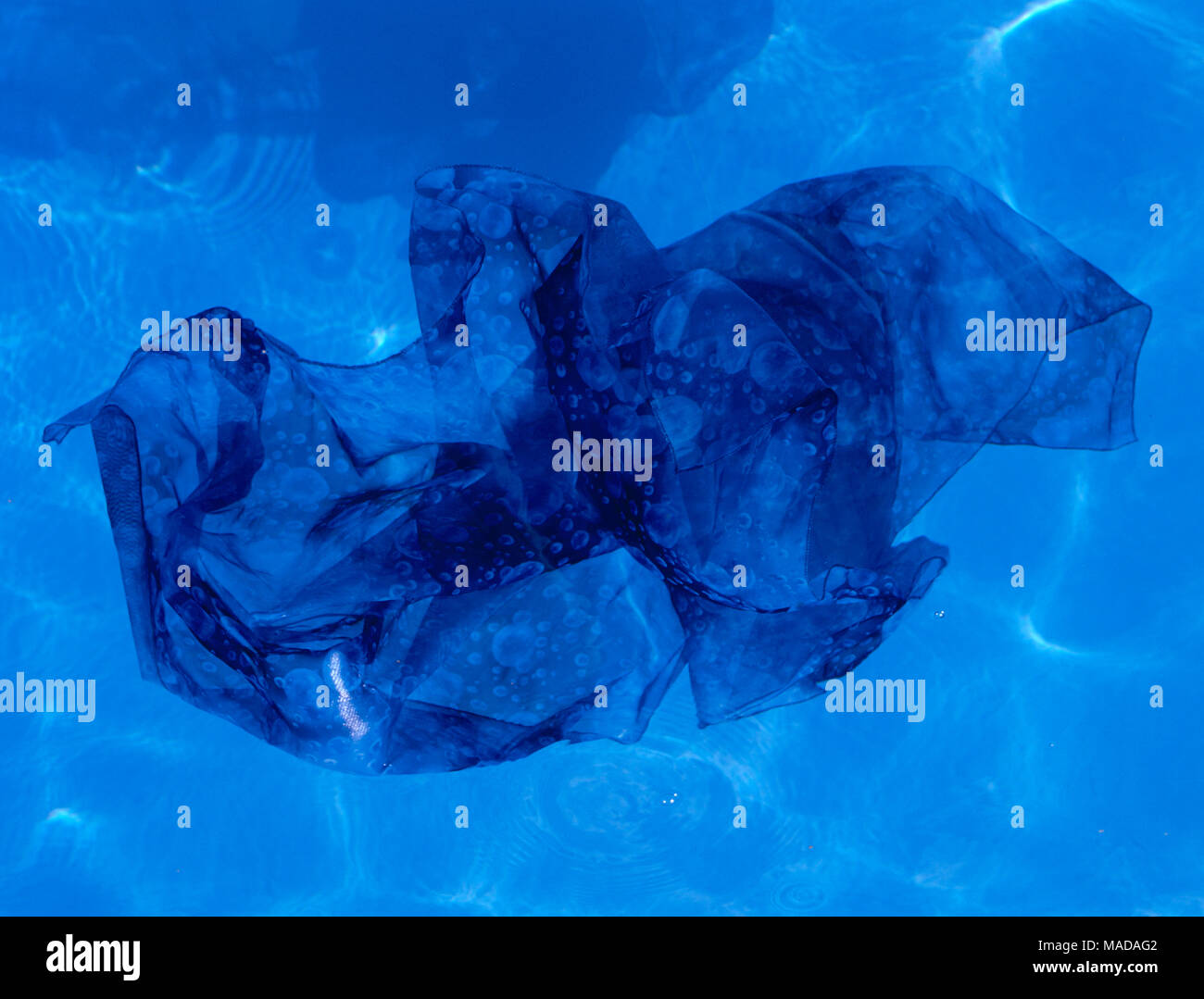 Blue fabric floating in pool Stock Photo - Alamy