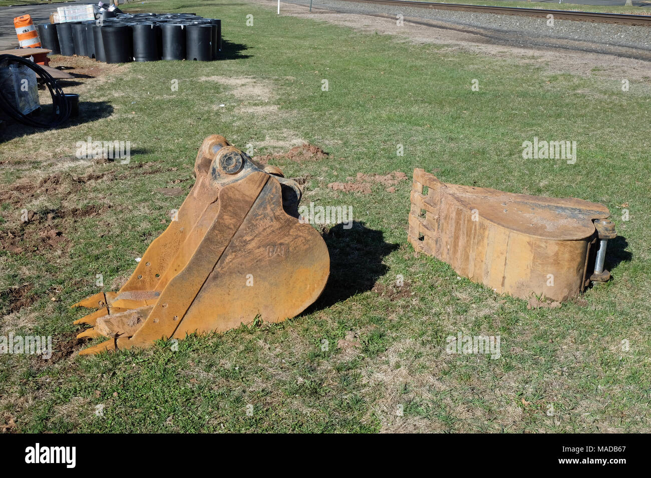 Backhoe buckets at a work site Stock Photo - Alamy