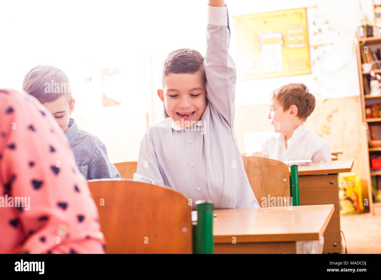 Active boy wants to give an answer Stock Photo - Alamy