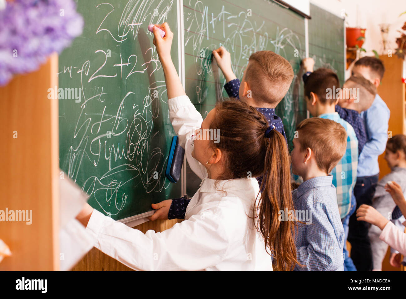 classmates are drawing on a board during the break Stock Photo - Alamy