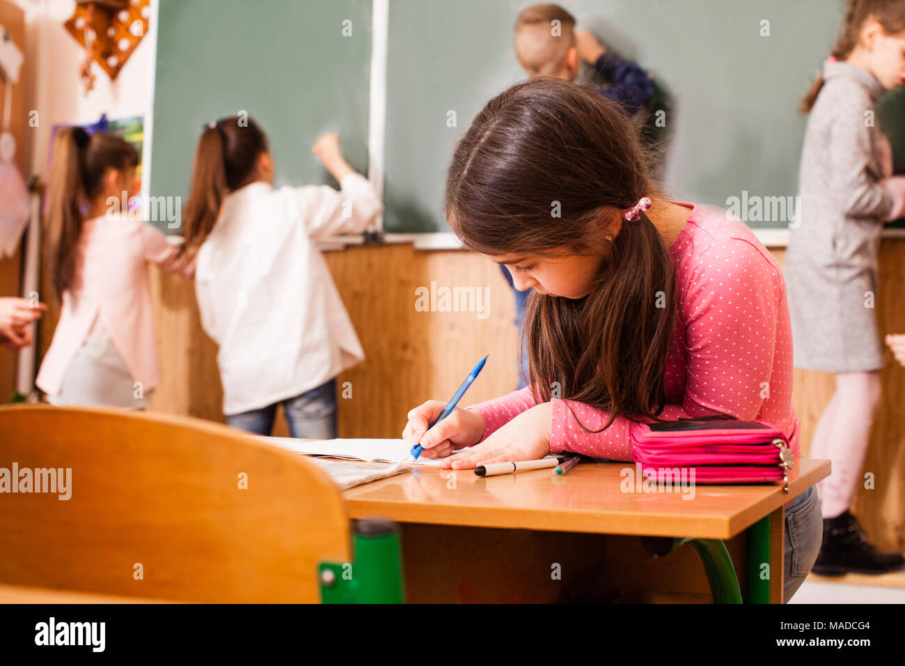 A hard-working girl is working on her homework Stock Photo - Alamy