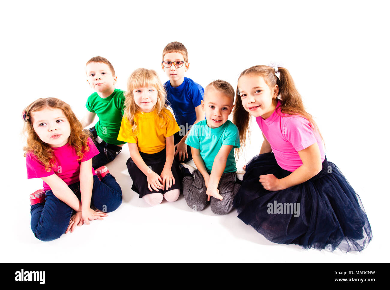 Smiling kids sitting Stock Photo - Alamy