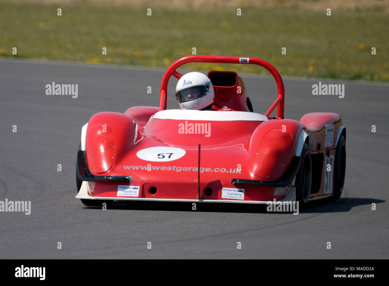 Red sports car driving on a race track. United Kingdom Stock Photo - Alamy