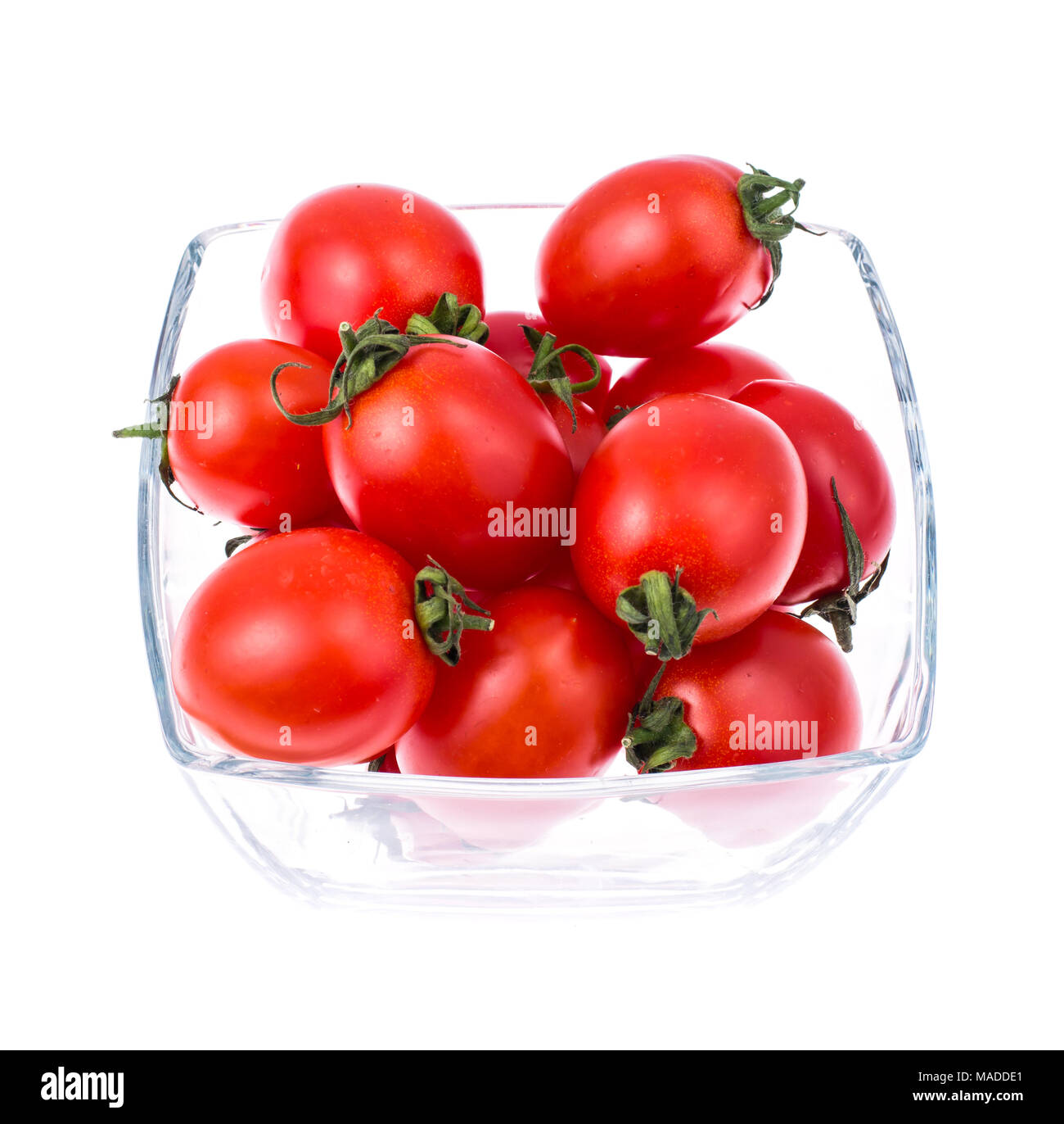 Small red cocktail tomatoes in glass bowl. Studio Photo Stock Photo - Alamy