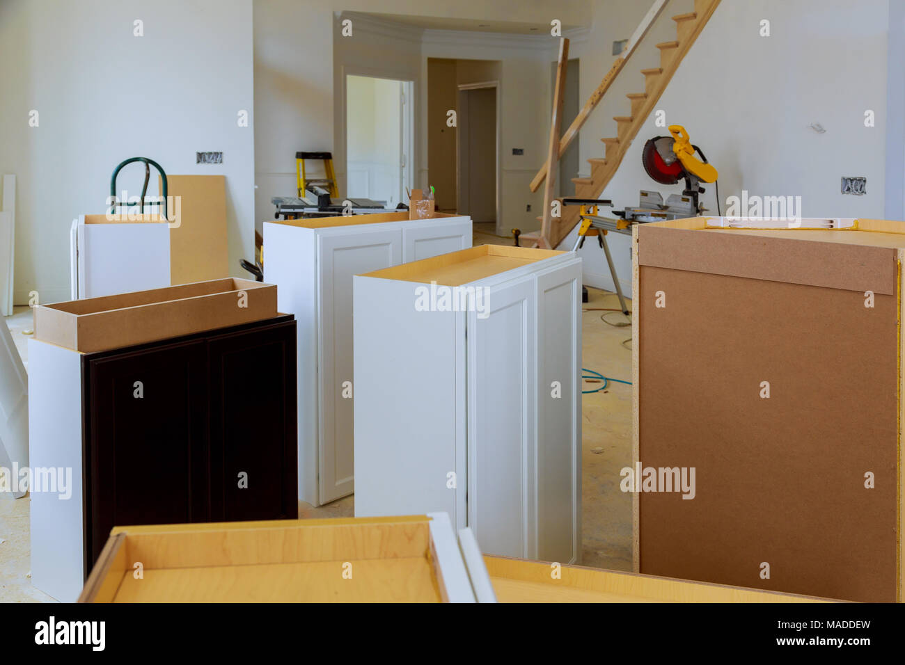 Installing new induction hob in modern installation of kitchen cabinet ...