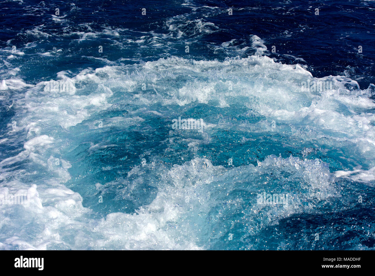 Turbulence made by the foam of sea water from a high-speed yacht on the ...