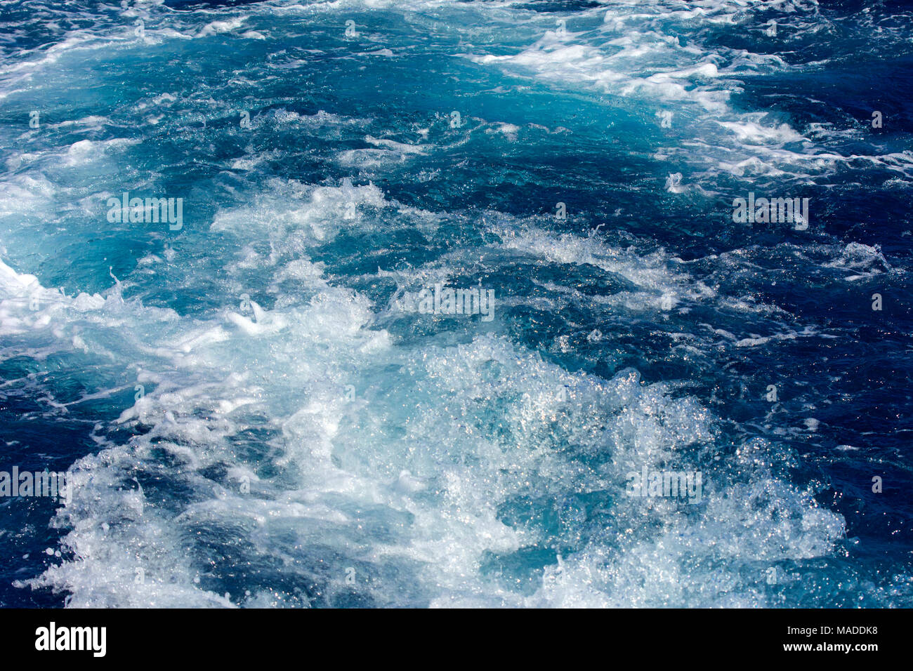 Turbulence made by the foam of sea water from a high-speed yacht on the ...