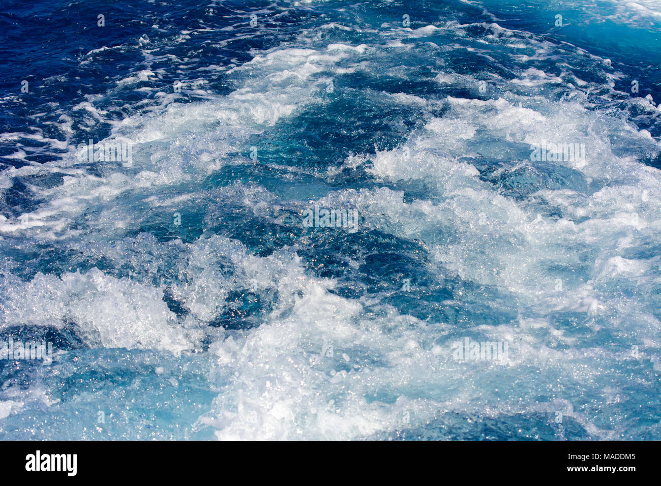 Turbulence made by the foam of sea water from a high-speed yacht on the ...