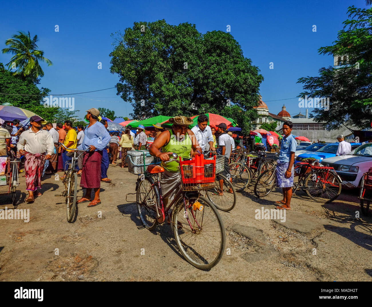 Yangon, Myanmar - Oct 16, 2015. Rickshaw drivers waiting on street in ...