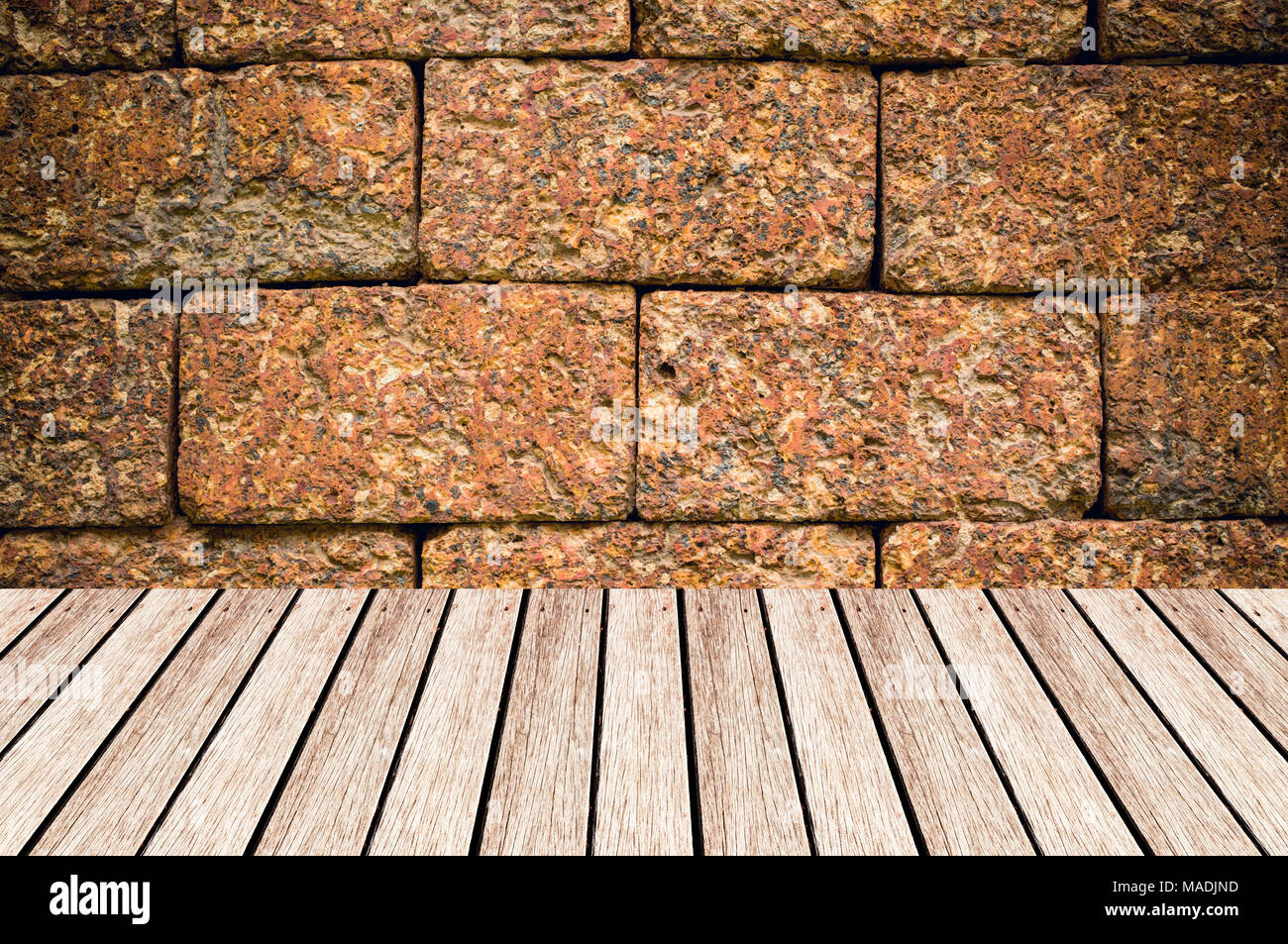 Wood table top on stone wall background - can be used for display or ...