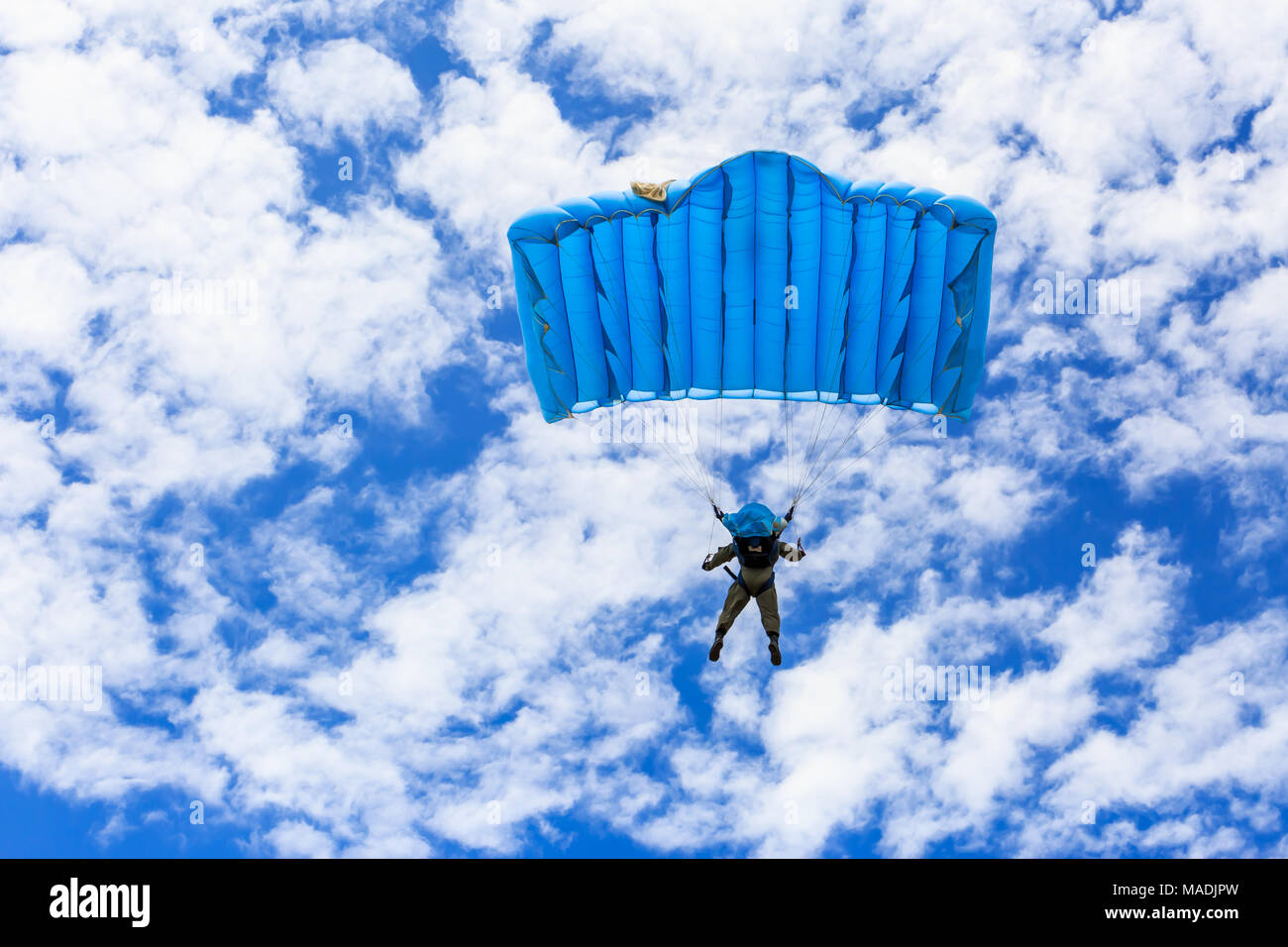 Parachute on blue sky Stock Photo - Alamy