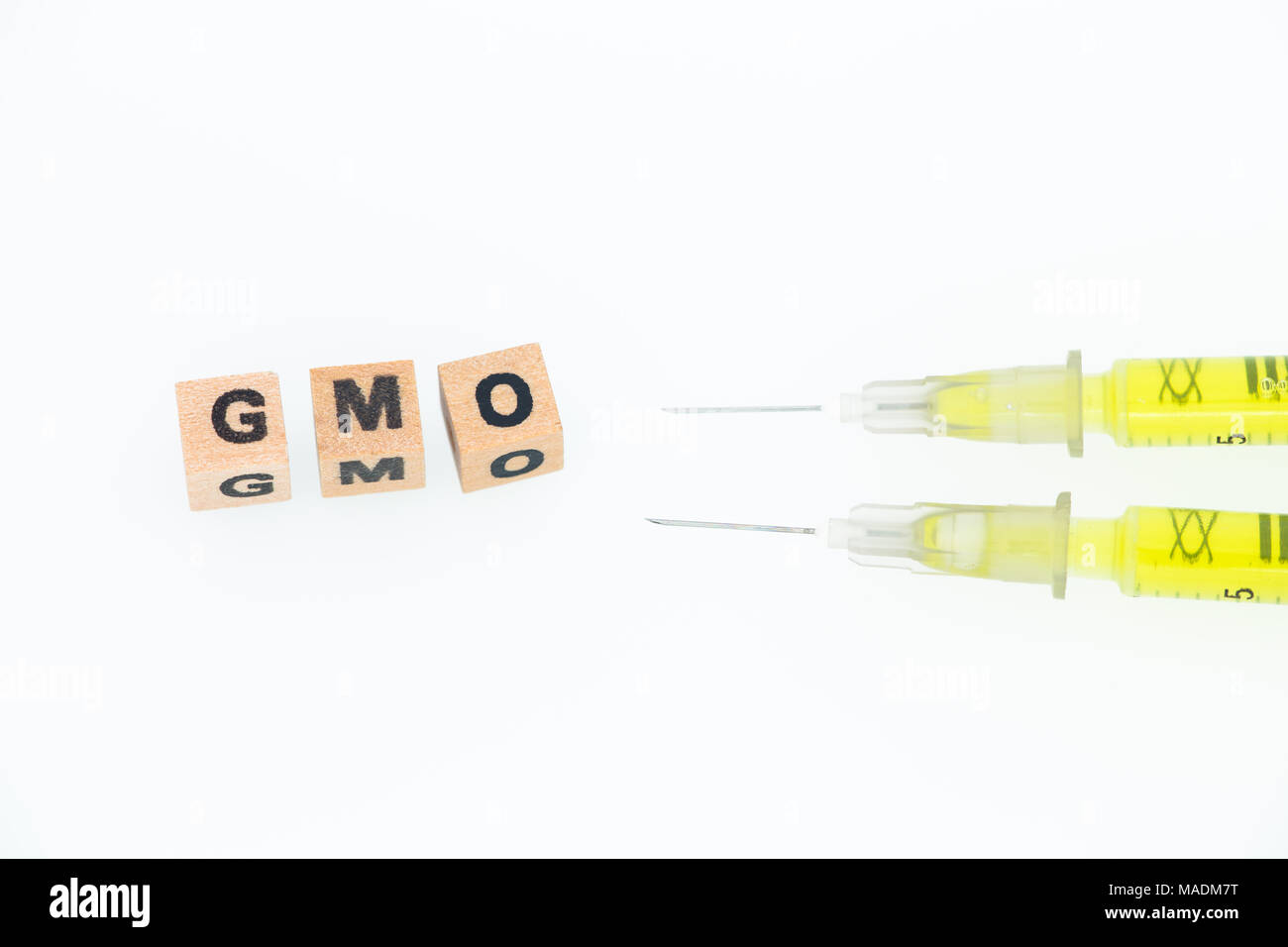 Syringes and gmo lettering Stock Photo - Alamy
