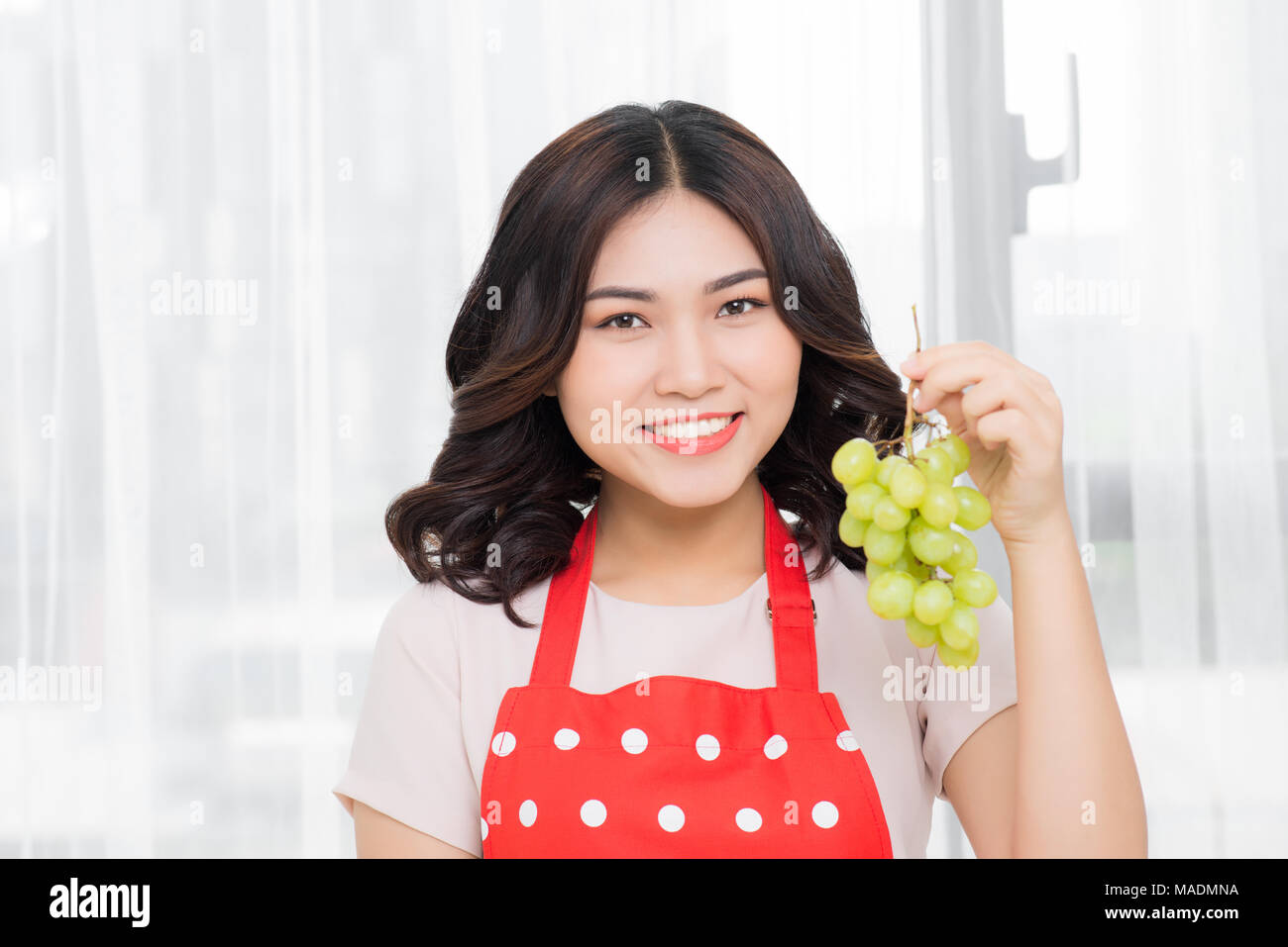 Woman eating grapes hi-res stock photography and images - Alamy