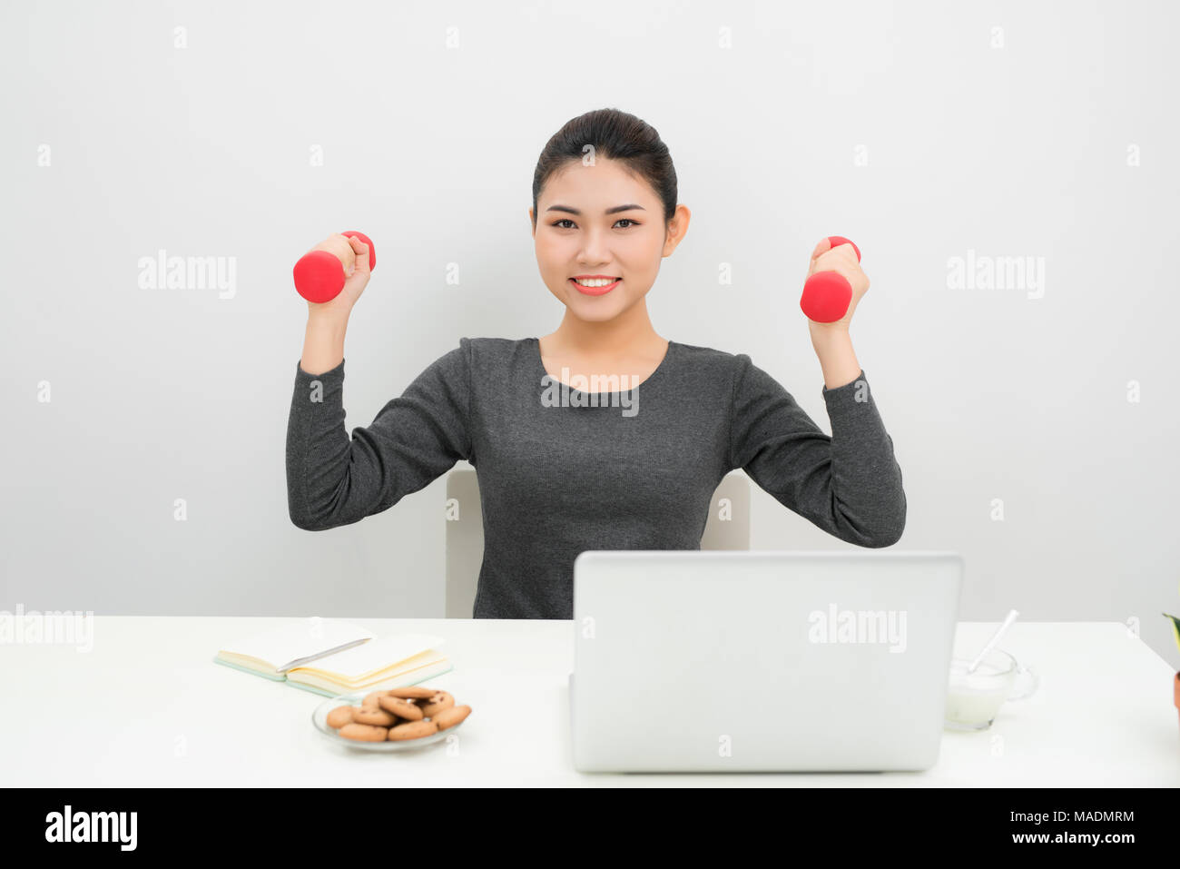 Business woman working and workout at her office Stock Photo - Alamy