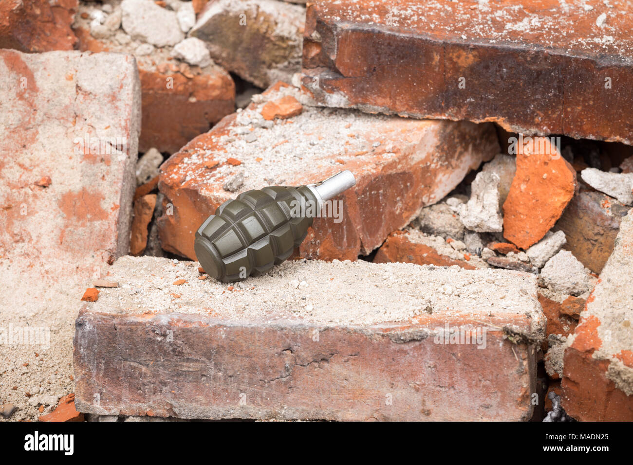 Hand grenade lying on a brick wall Stock Photo - Alamy