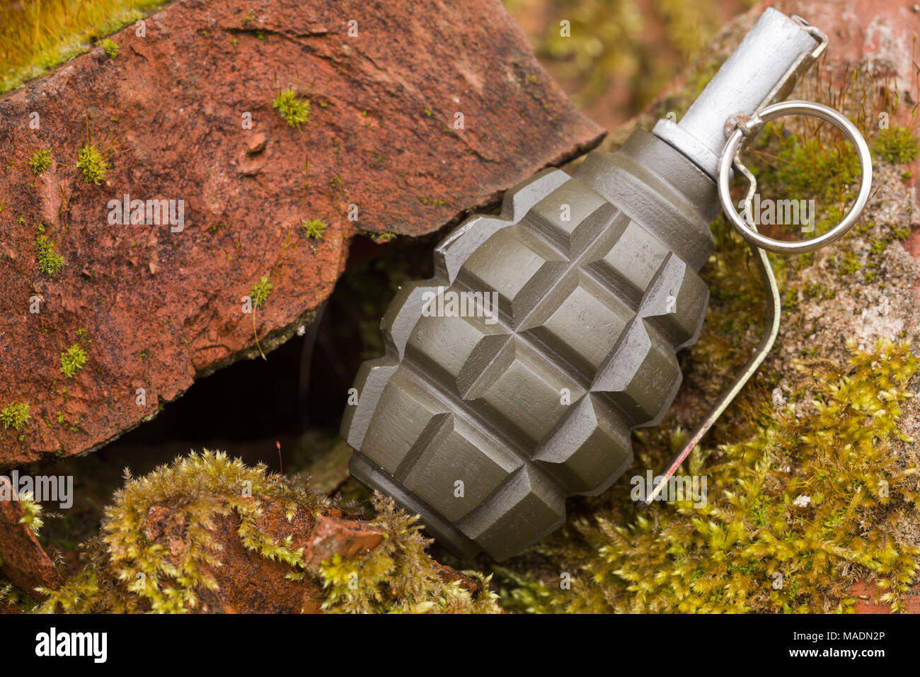 Hand grenade lying on a brick wall Stock Photo - Alamy