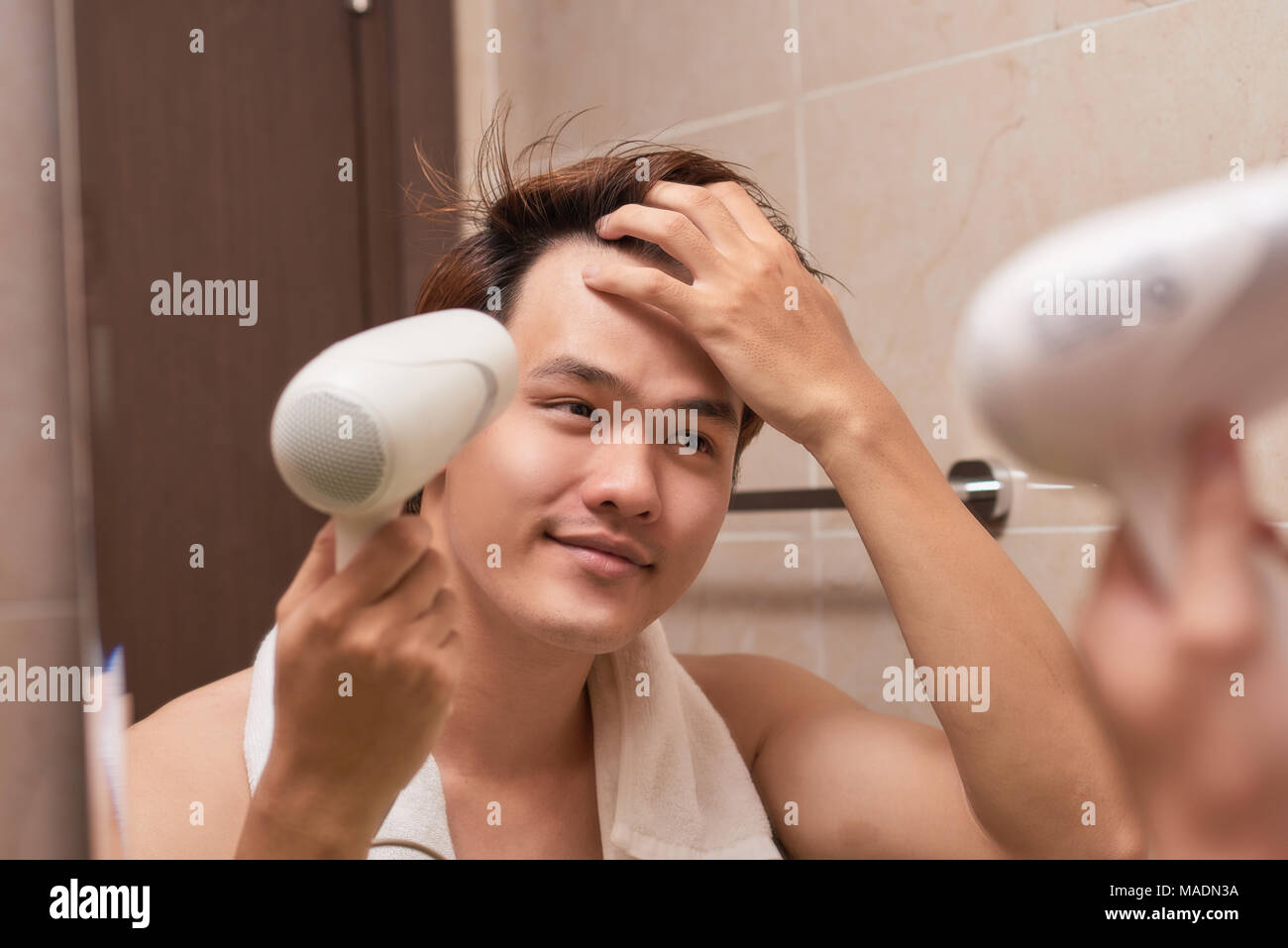 Woman blow drying hair in hi-res stock photography and images - Alamy