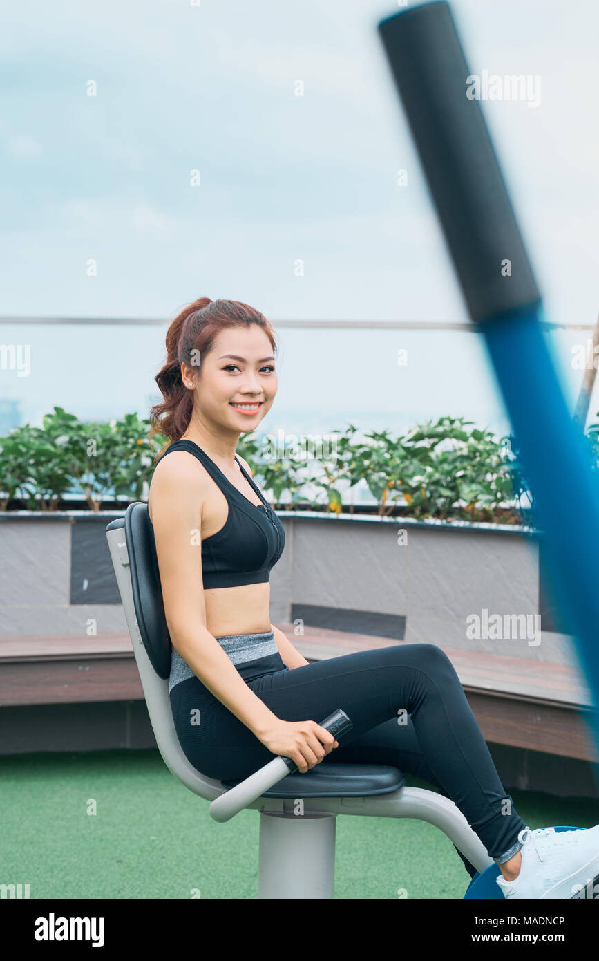 Asian woman exercising at outdoors gym playground equipment Stock Photo ...