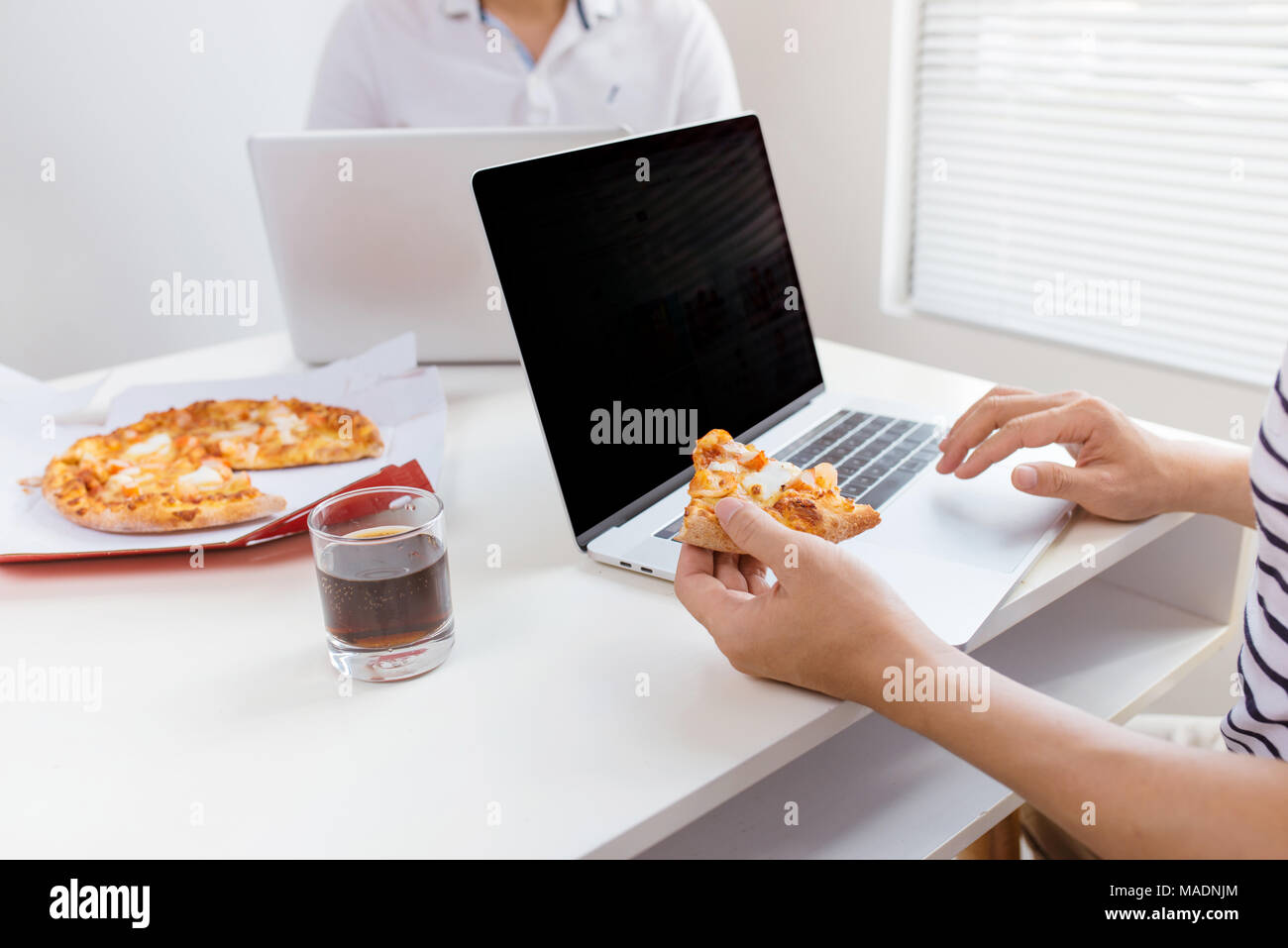 Lunch and people concept. Happy business team eating pizza in office ...