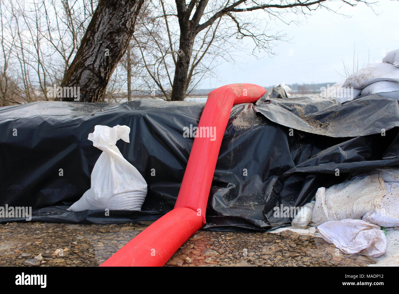 Sandbag flood protection covered with black nylon and held with new ...