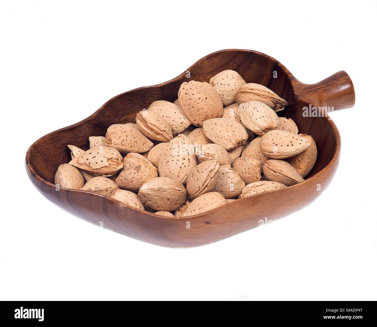 Raw almonds in shell in wooden vintage bowl isolated on white ...