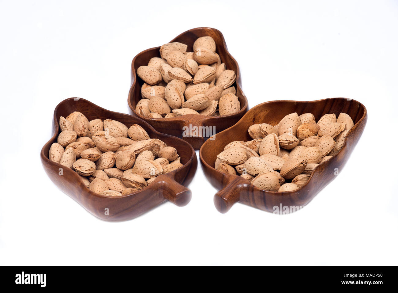 Raw almonds in shell in wooden vintage bowl isolated on white ...