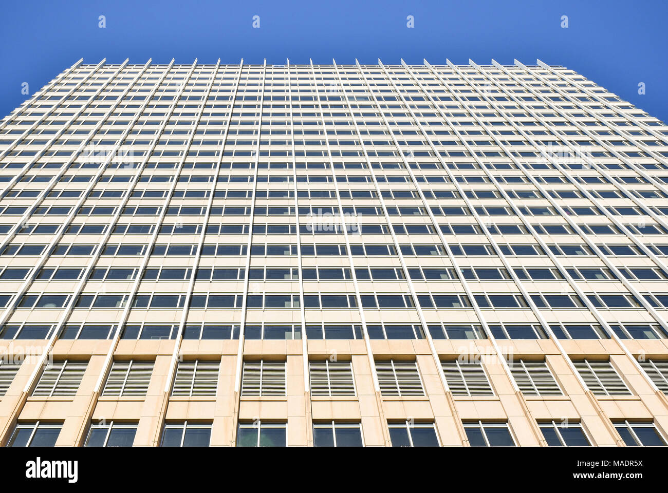 the facade of an office building looking from the ground up to the sky ...