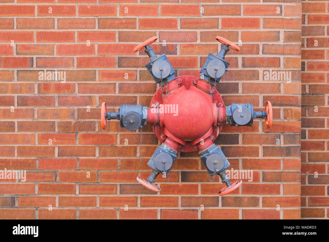 Multi-outlet fire Hydrant and hose connection point in a brick wall ...